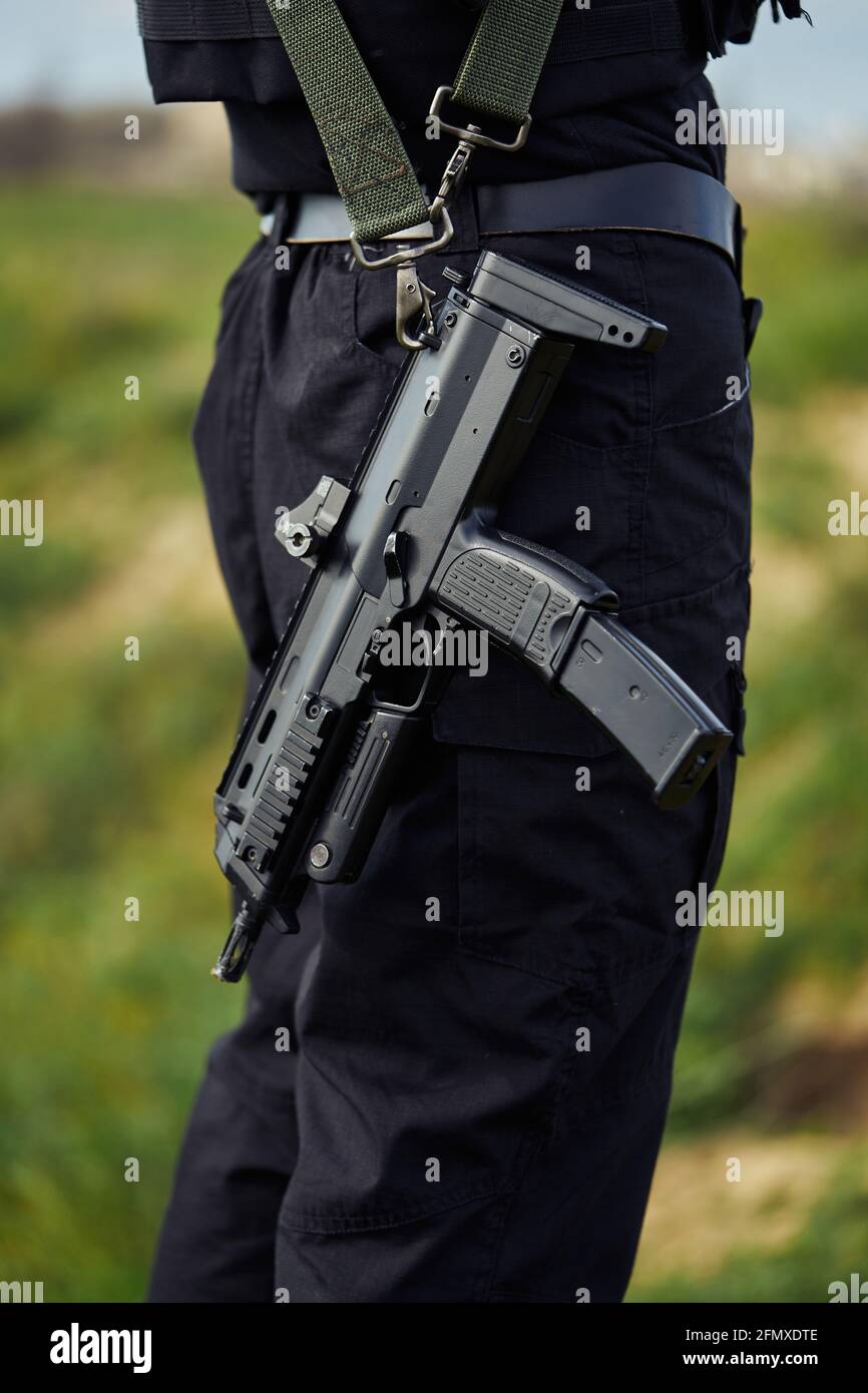 Close-up of a submachine gun of a police officer in black uniform Stock ...