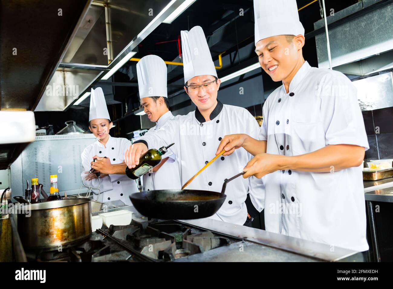 Asian Chefs in restaurant kitchen cooking Stock Photo - Alamy