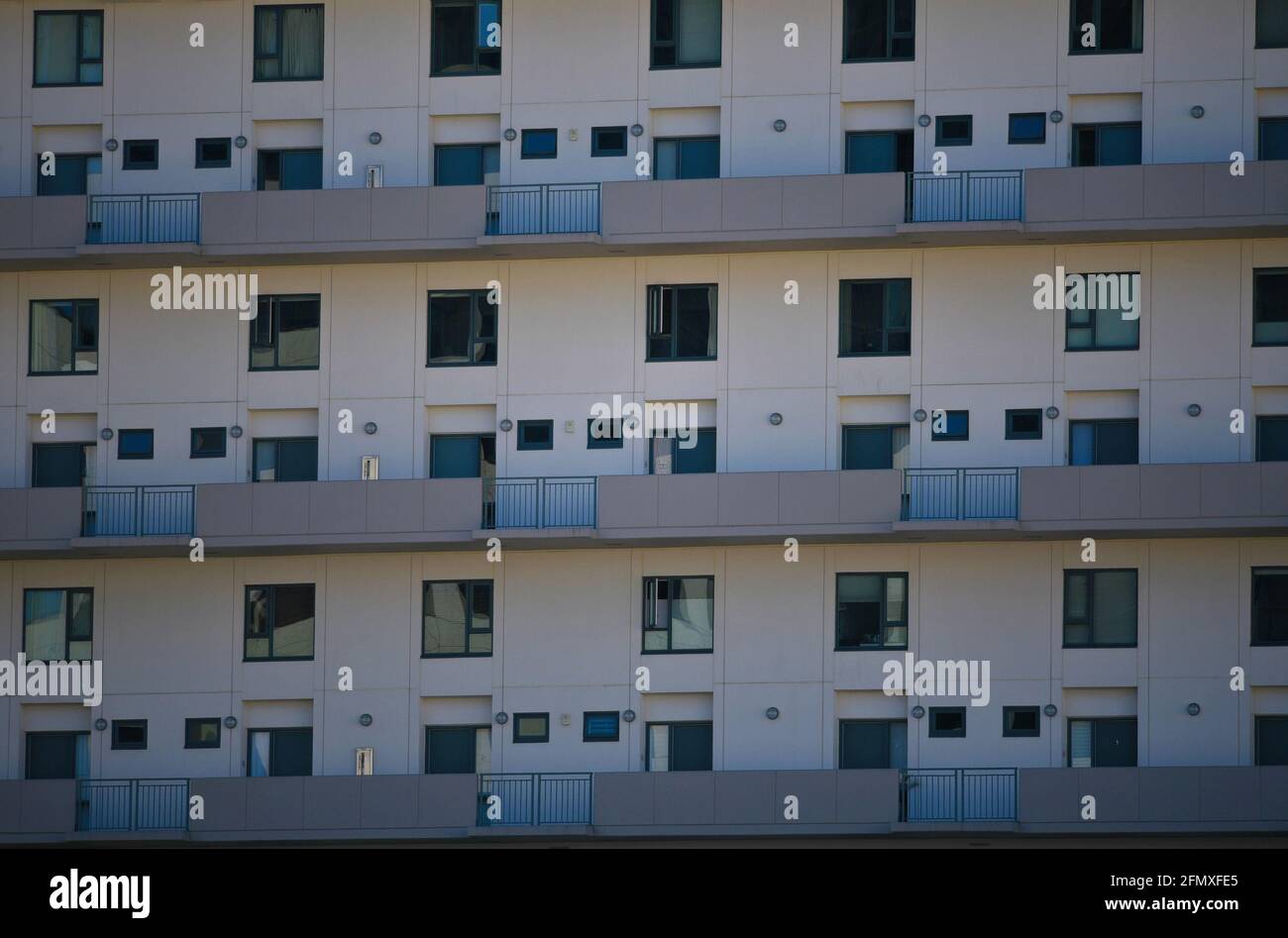 Residential building concrete facade with symmetrical windows and ...