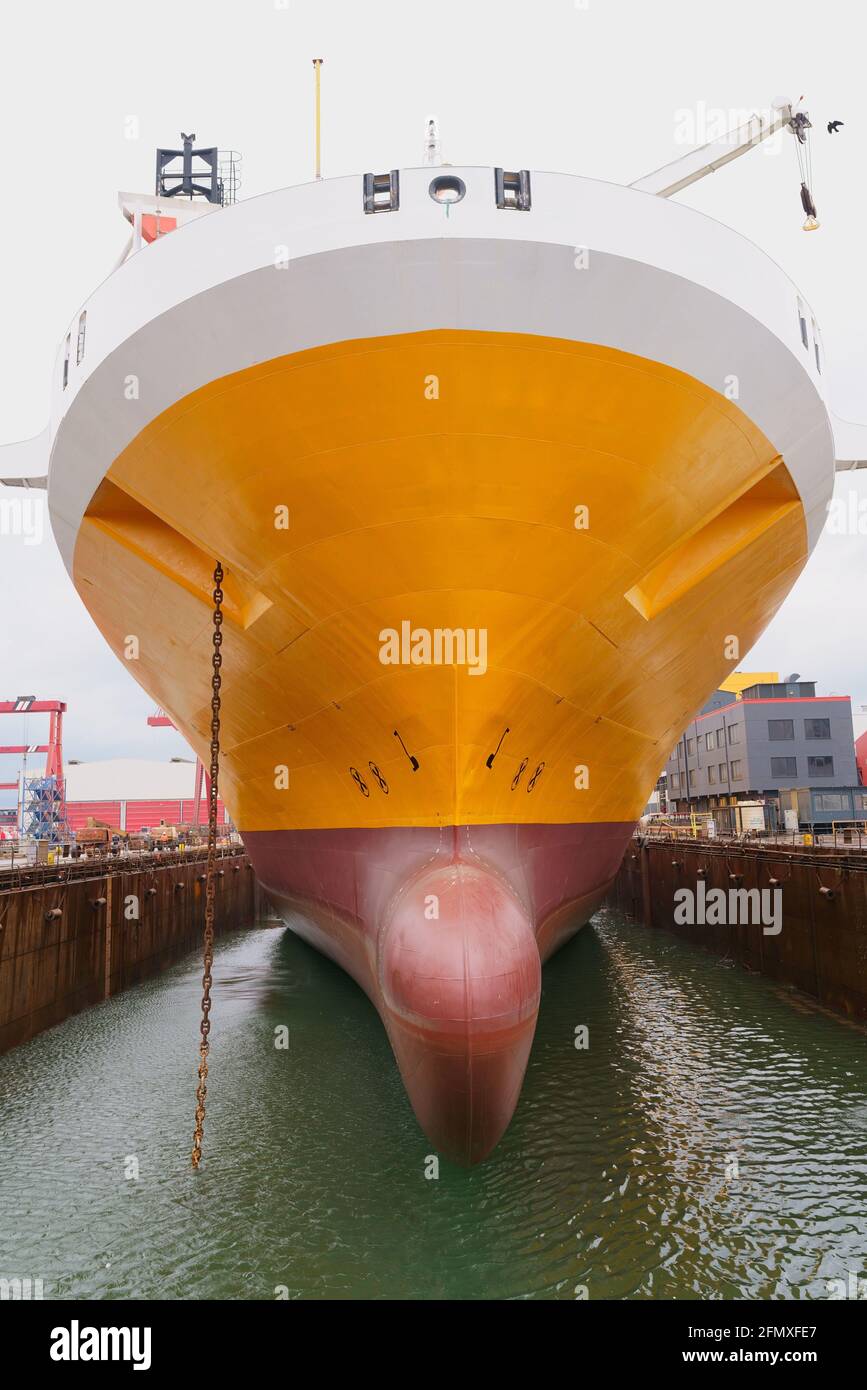 orange side paint cargo vessel in dock Stock Photo - Alamy