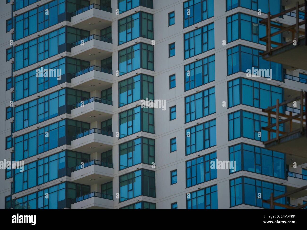 Residential condominiums complex facade with symmetrical white concrete ...