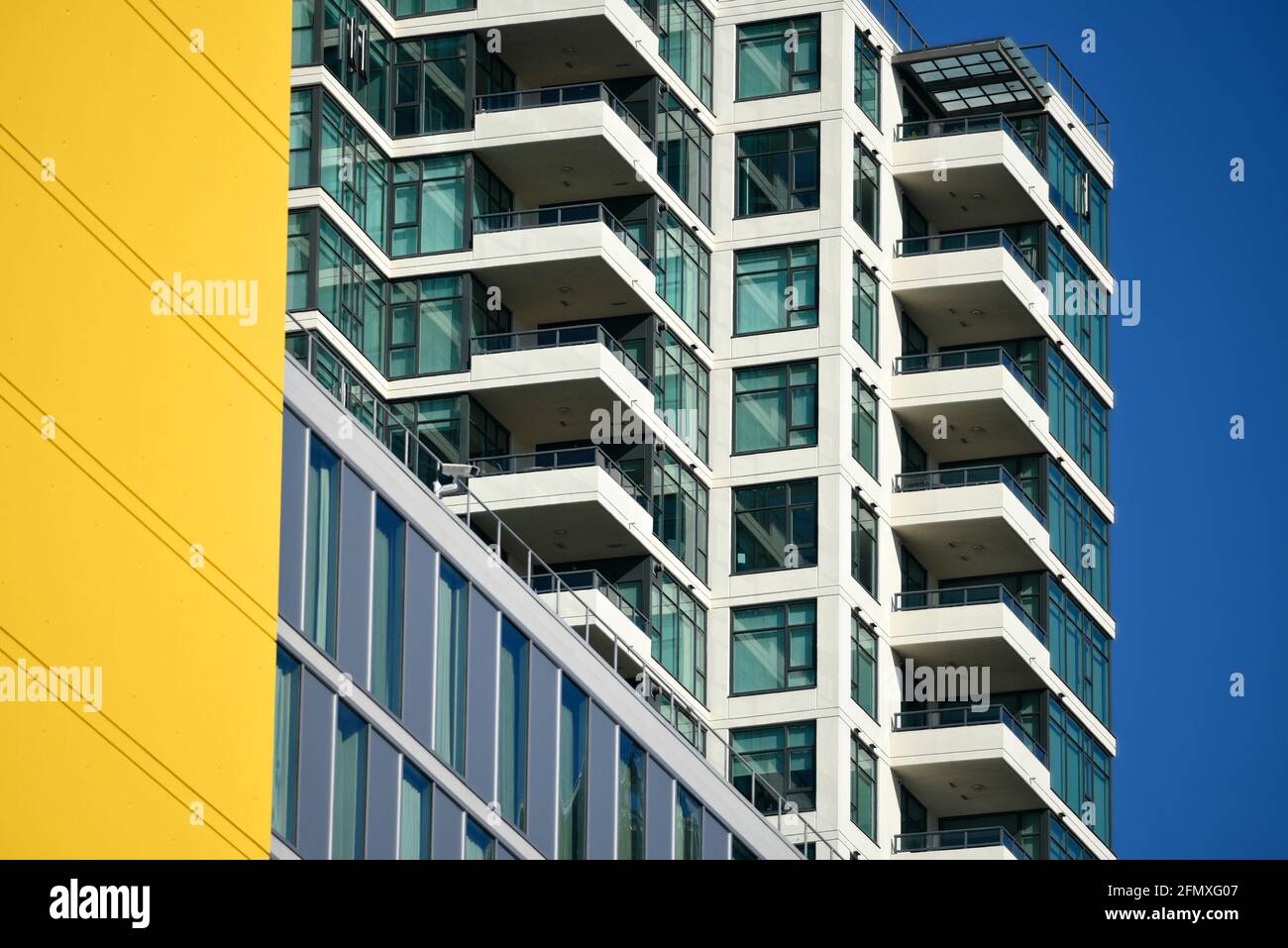 Residential condominiums complex facade with symmetrical balconies and ...