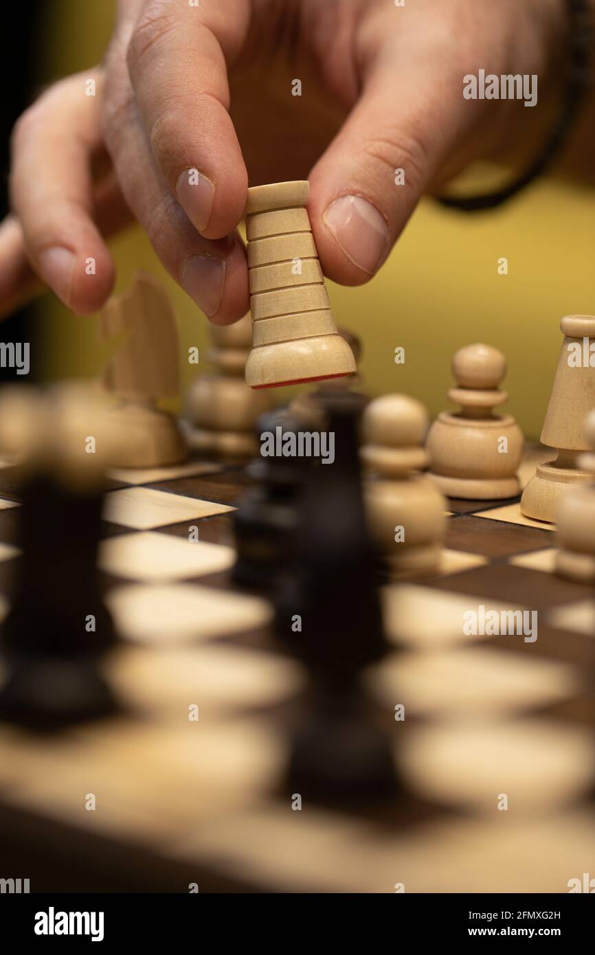 Hand taking next step on chess game. Human hand moving wooden white ...