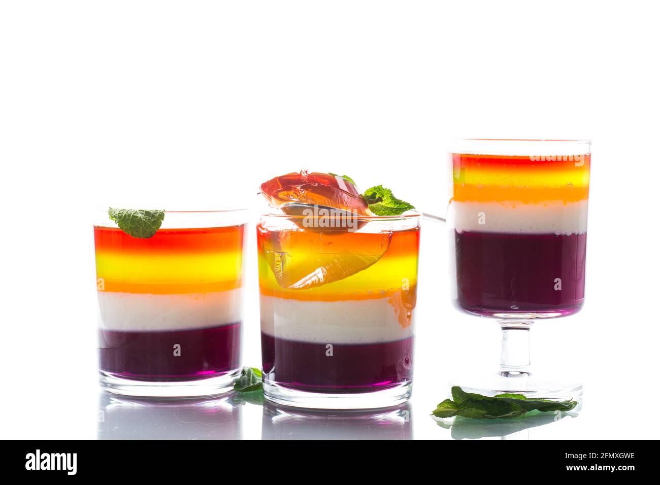 lot of colored sweet fruit jelly in a glass isolated on white ...