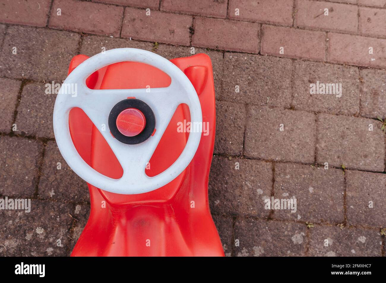 Top view of a steering wheel of a toy car on a brick ground Stock Photo ...