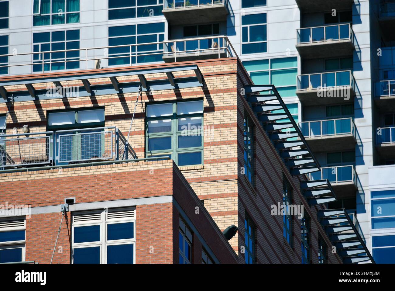 Residential complex high-rise building concrete, brick and glass facade ...