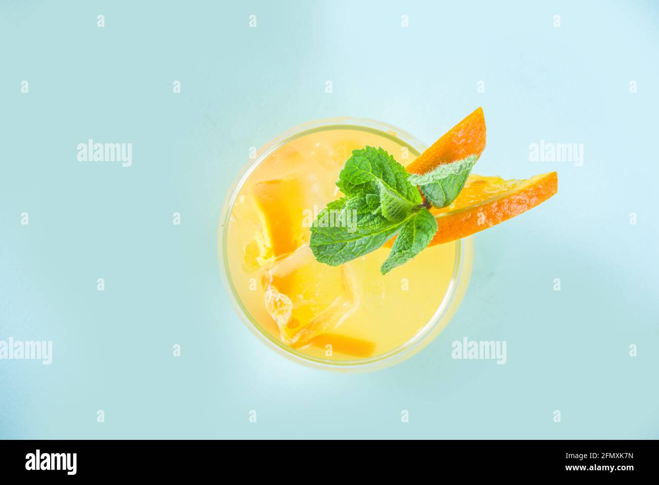 One glass with summer cold drink lemonade with orange slices, ice and ...