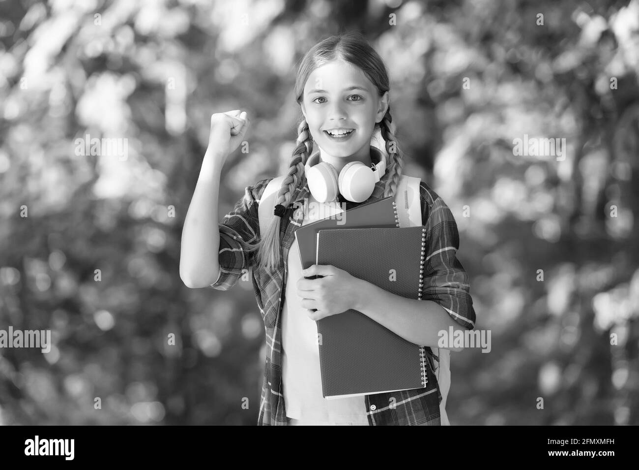 Homework done. Happy kid celebrate back to school. Little child hold ...