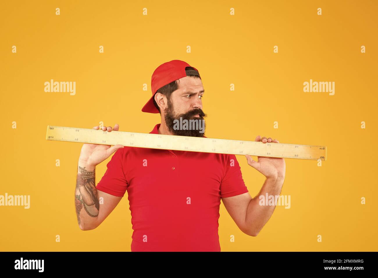 Measuring with ruler. School teacher hold ruler yellow background ...