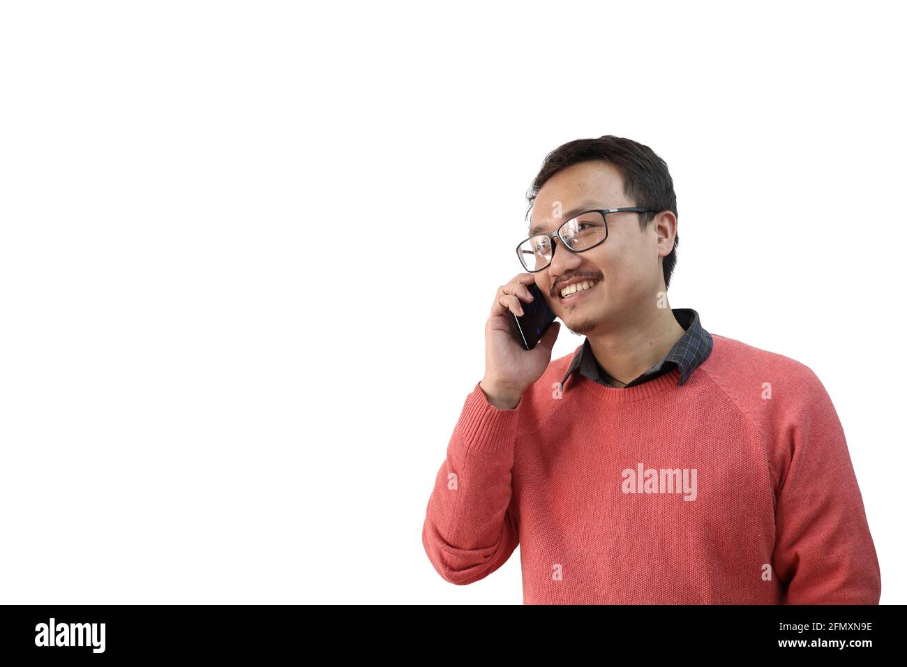 Asian man talking over his phone isolated on a white background with ...