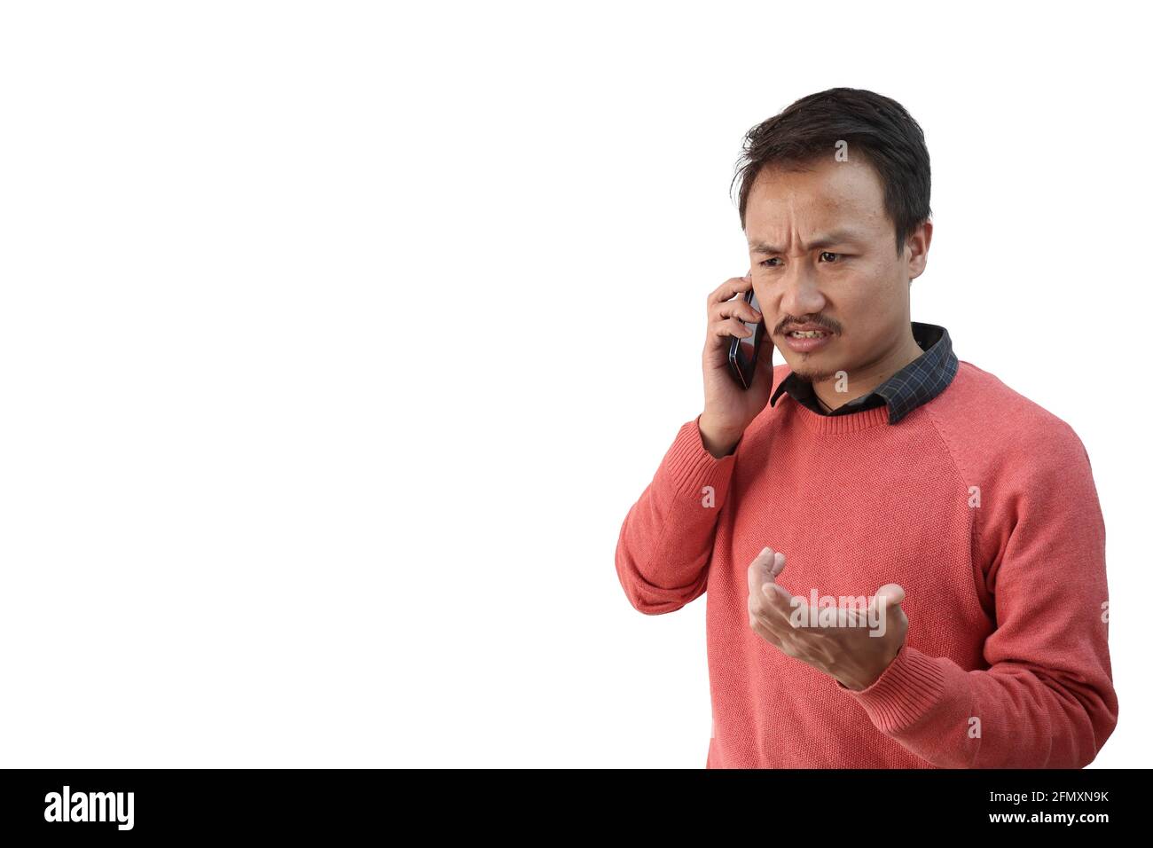 Asian man talking over his phone isolated on a white background with ...