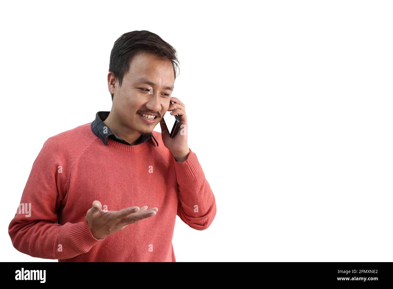 Asian man talking over his phone isolated on a white background with ...