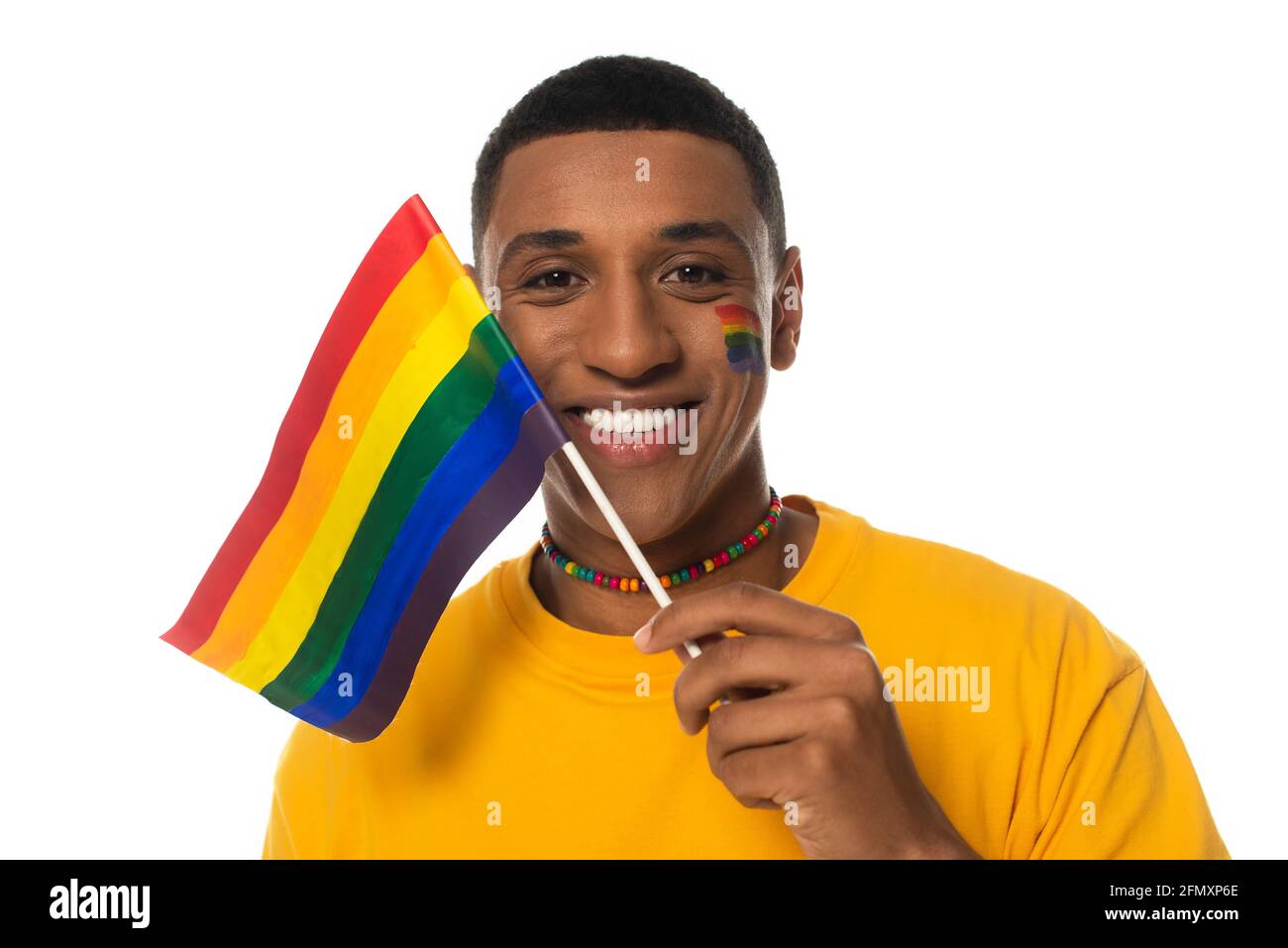 happy african american man with small lgbt flag looking at camera ...