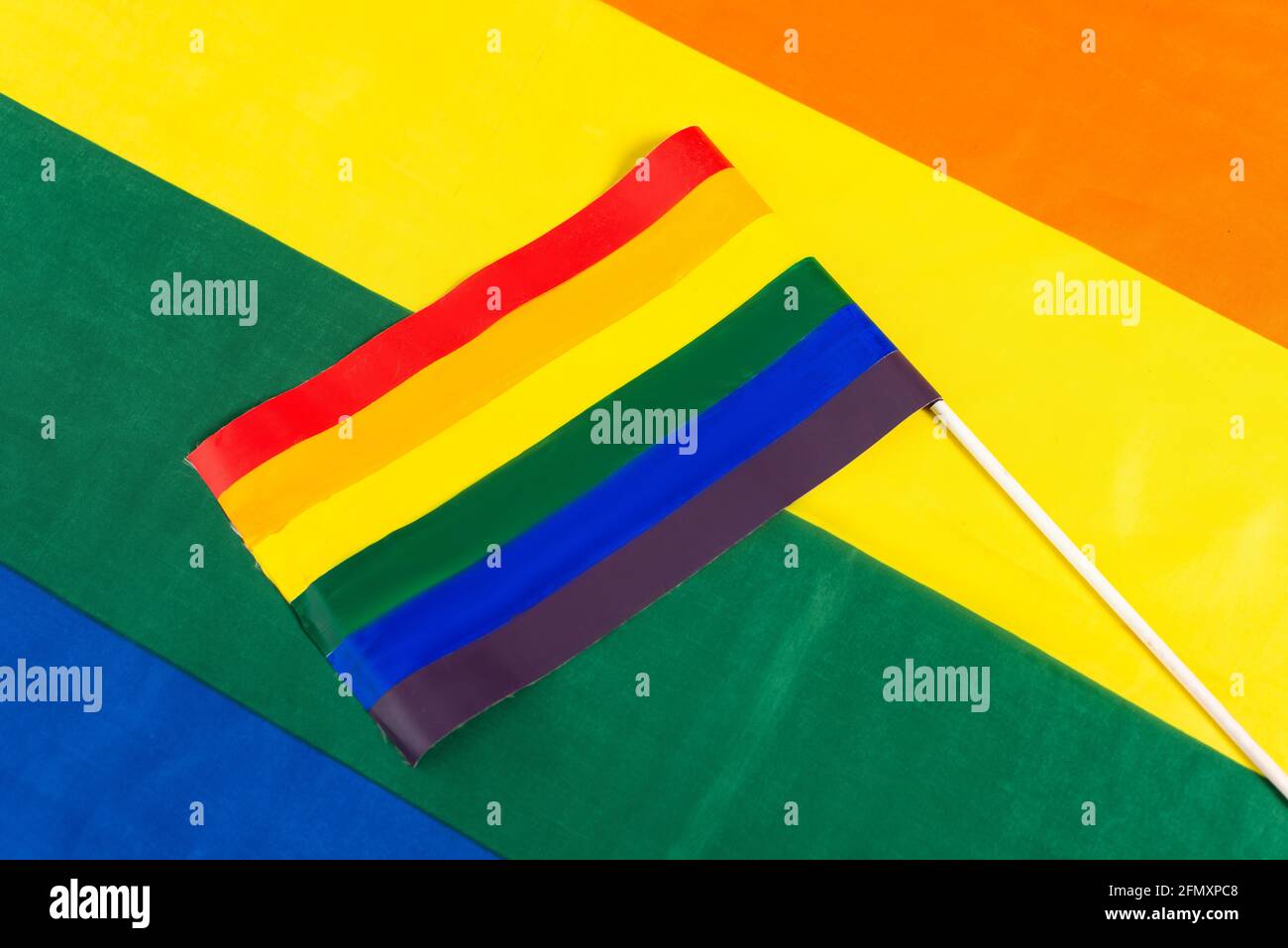 top view of small lgbt flag on rainbow colors background Stock Photo ...