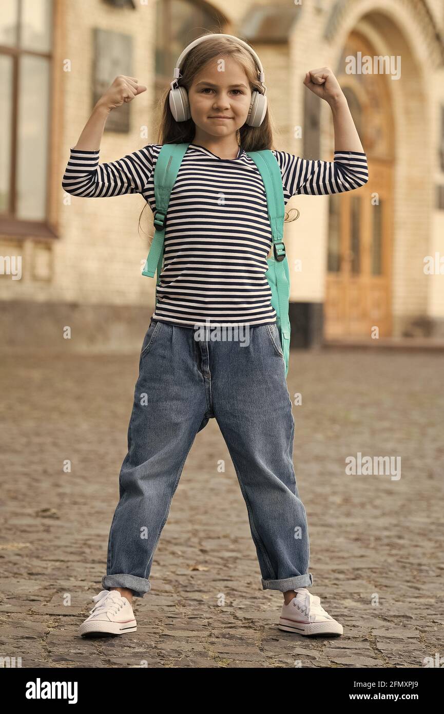 Beauty gives power. Small kid flex arms outdoors. Girl power. Little ...