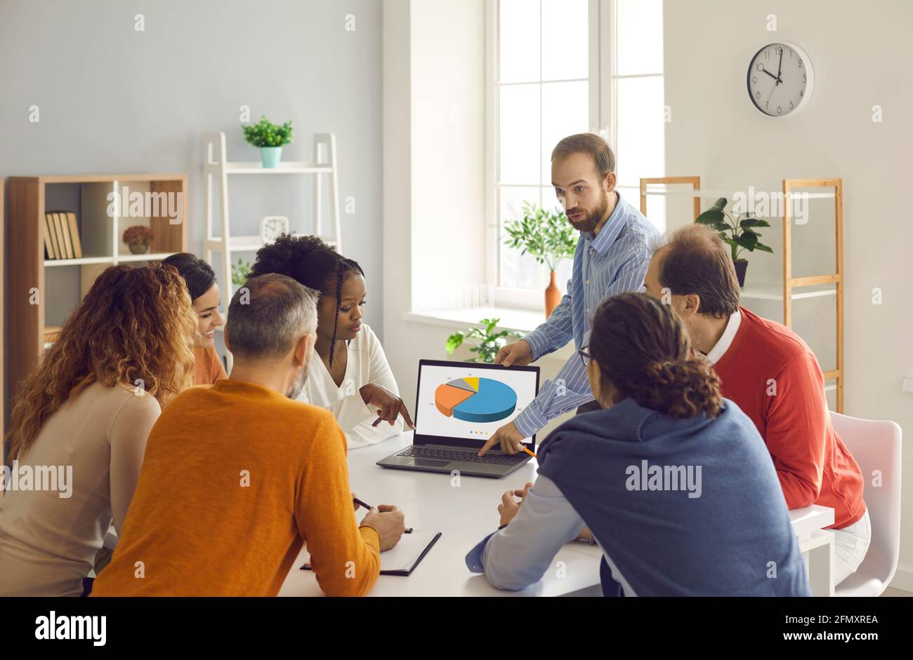 Business group leader making presentation and showing pie charts on ...
