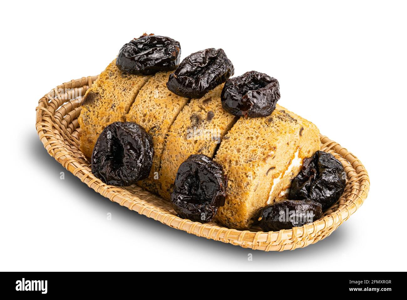 High angle view of prune sponge cake roll and dried pitted prune in ...