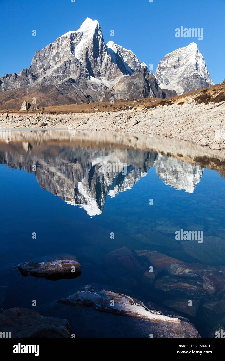 Mount Tabuche Peak mirroring in small mountain lake, Nepal Himalayas ...