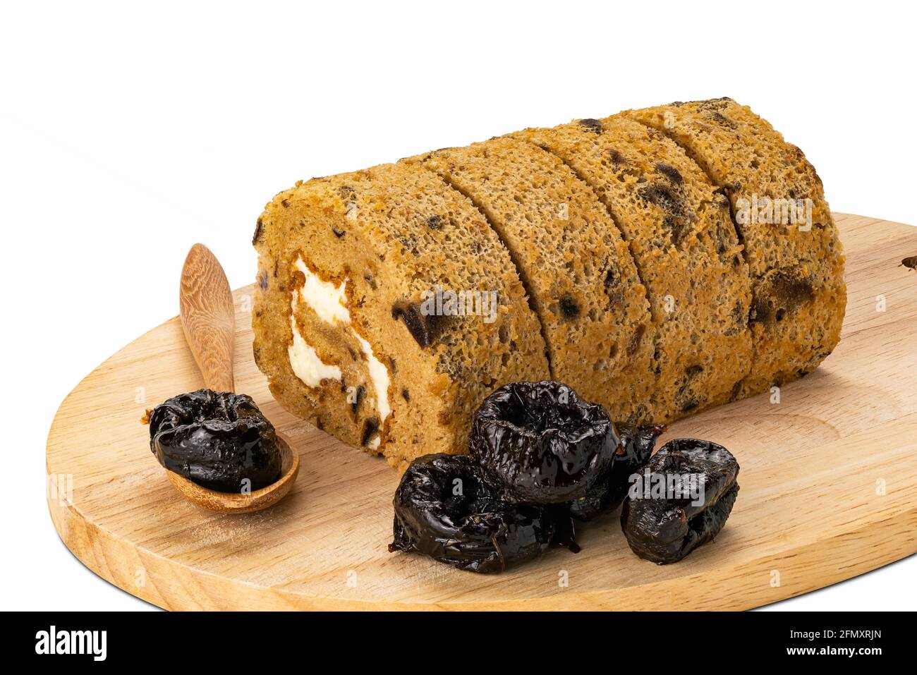 Closeup view sliced prune sponge cake roll, dried pitted prune in ...