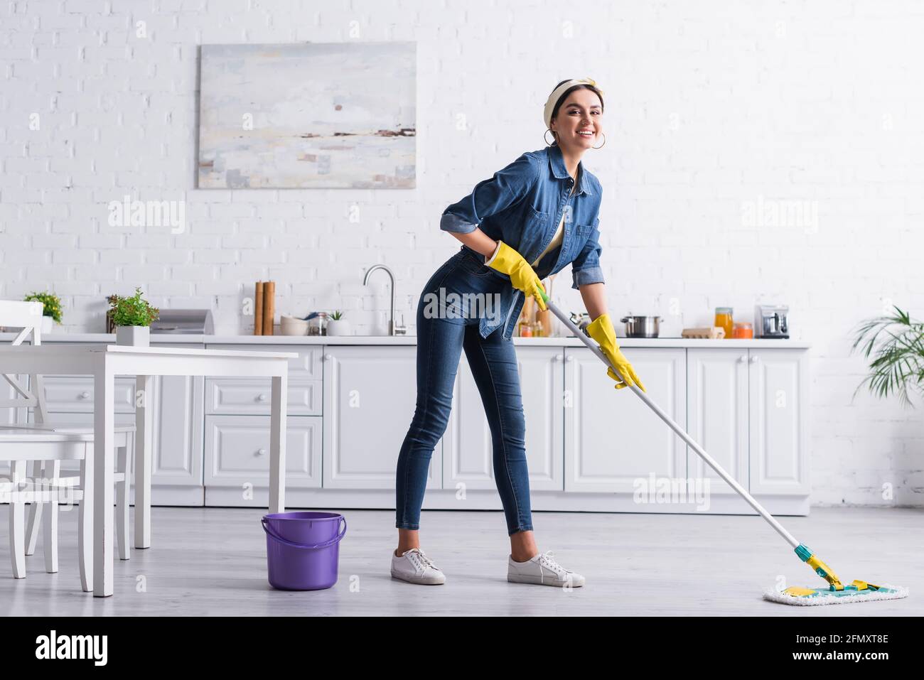 Woman with mop in kitchen hi-res stock photography and images - Alamy