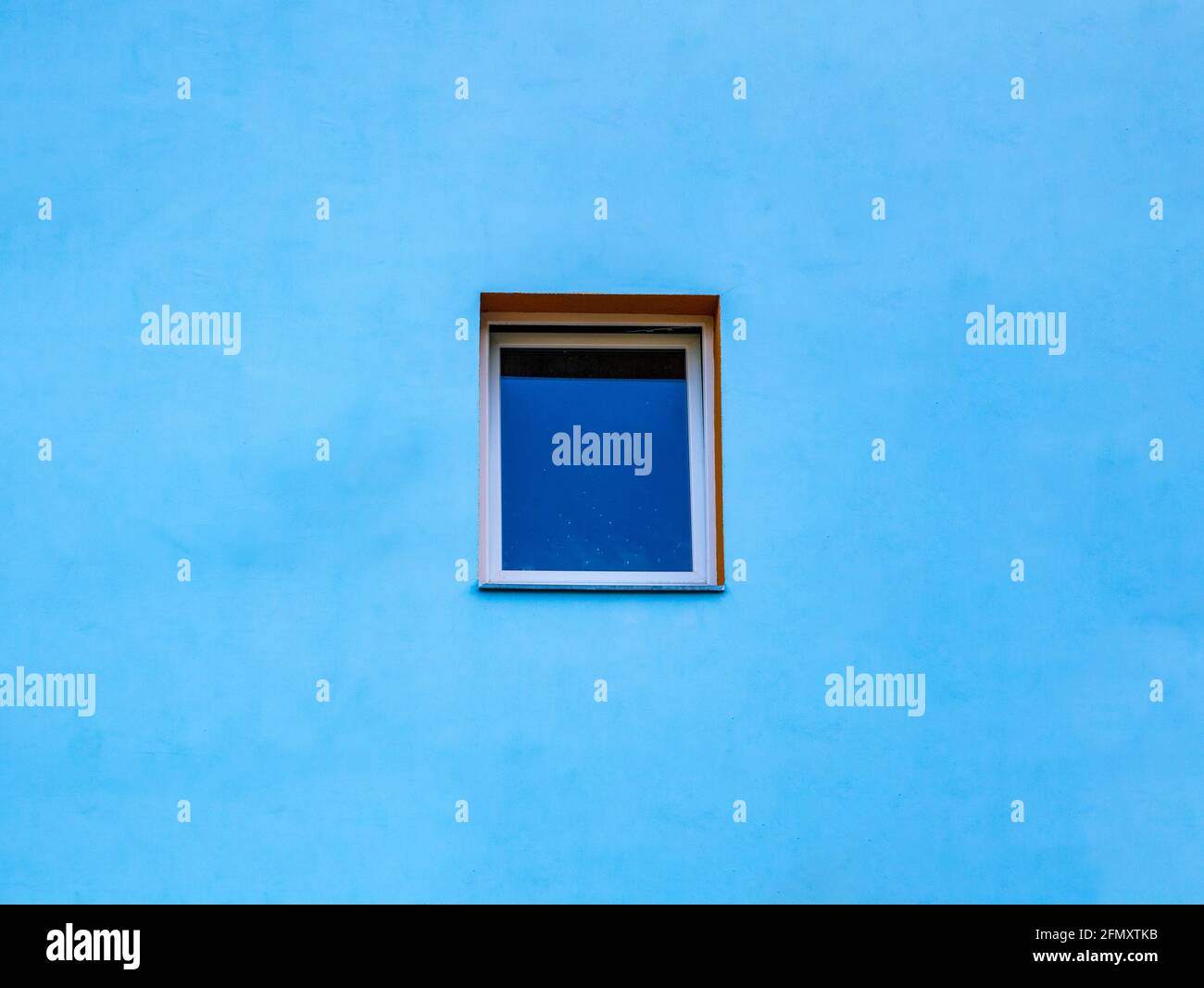 A modern window in the middle of a blue wall Stock Photo - Alamy