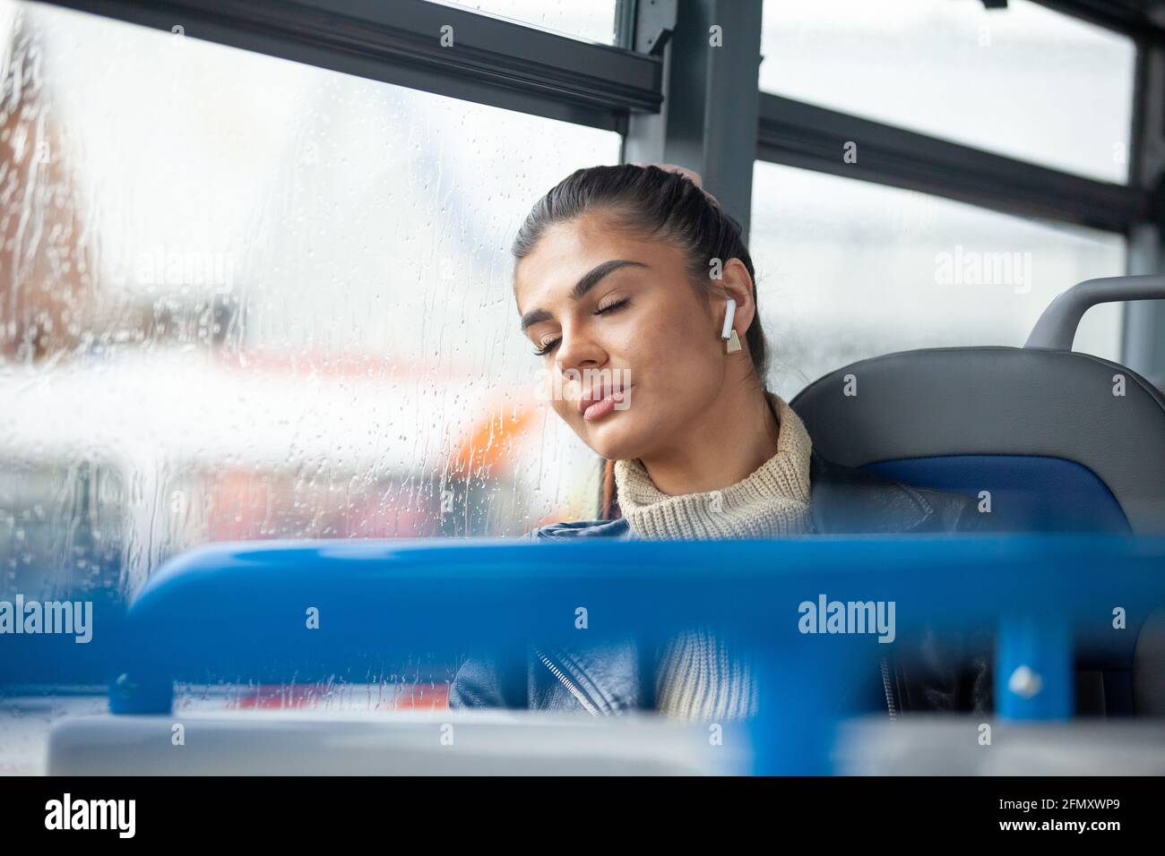 woman with her eyes closed on a bus listening to music Stock Photo - Alamy