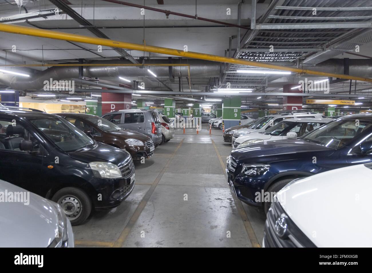 A multilevel car parking lot in the basement of a building with many ...