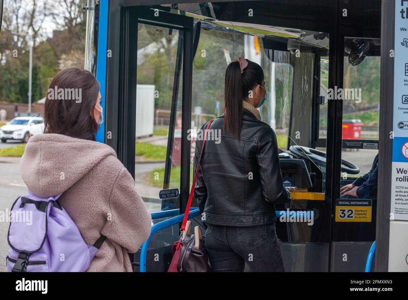 Two women getting on bus hi-res stock photography and images - Alamy