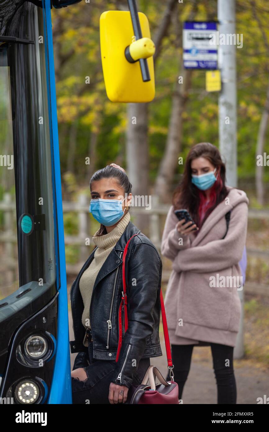 Two women getting on bus hi-res stock photography and images - Alamy