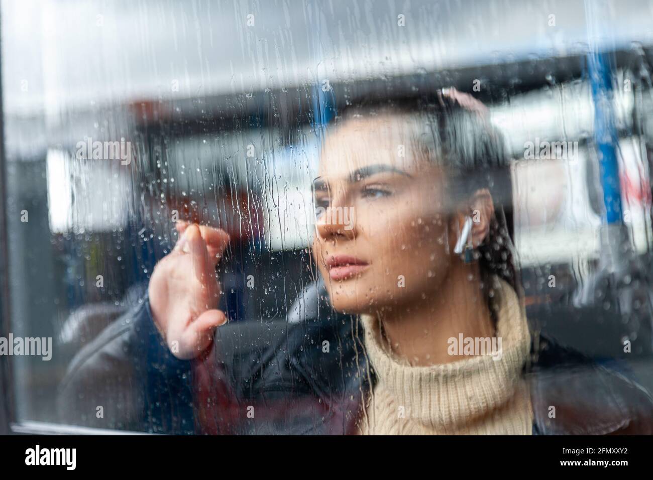 Girl staring out of rainy window on a bus Stock Photo - Alamy