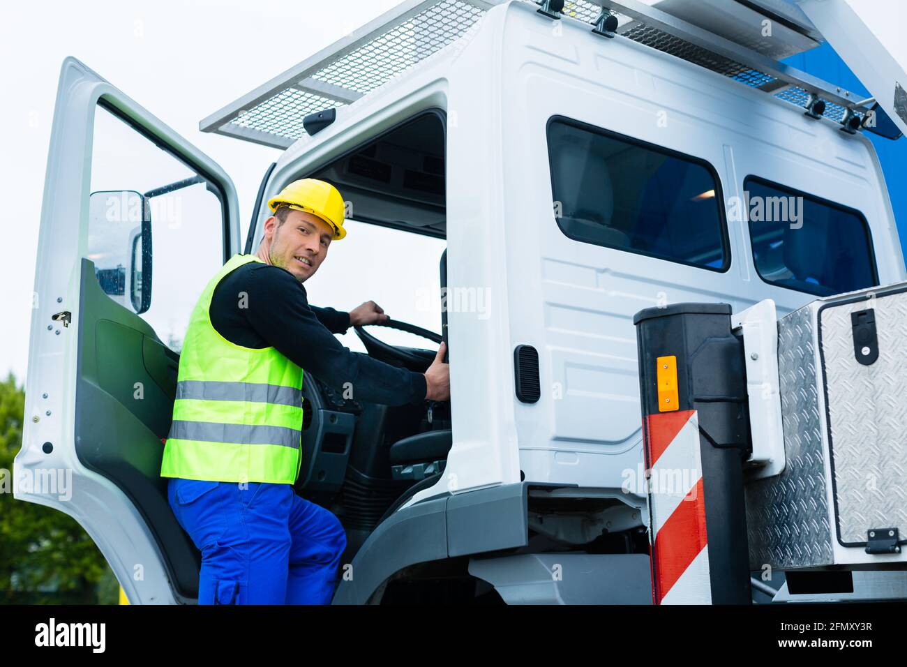 crane operator or driver driving with the truck over building or ...