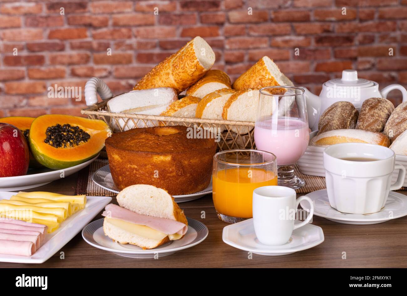 Breakfast table filled with various foods including breads, sweets ...