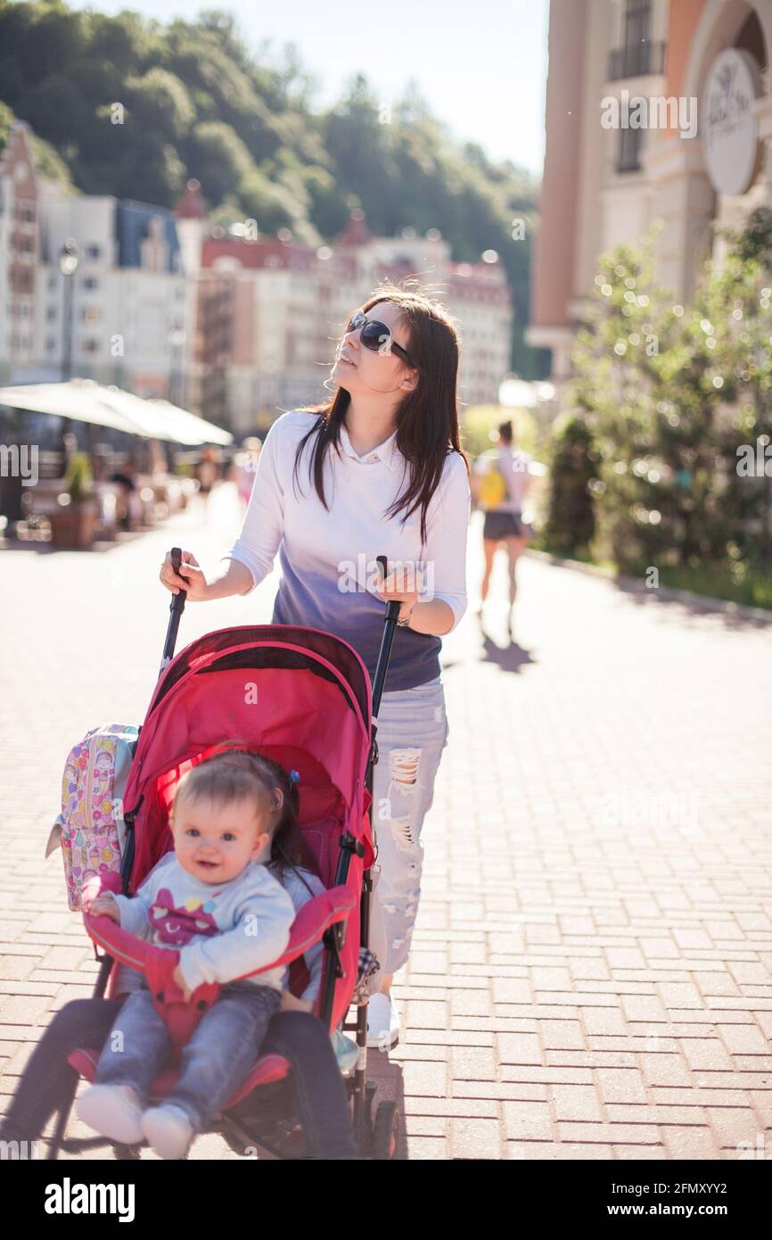 Baby walking hand in hand hi-res stock photography and images - Alamy