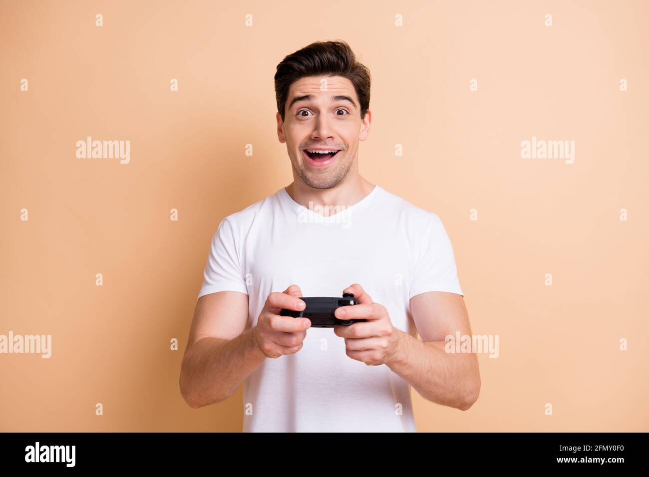 Portrait of impressed brunet man playstation wear white t-shirt ...