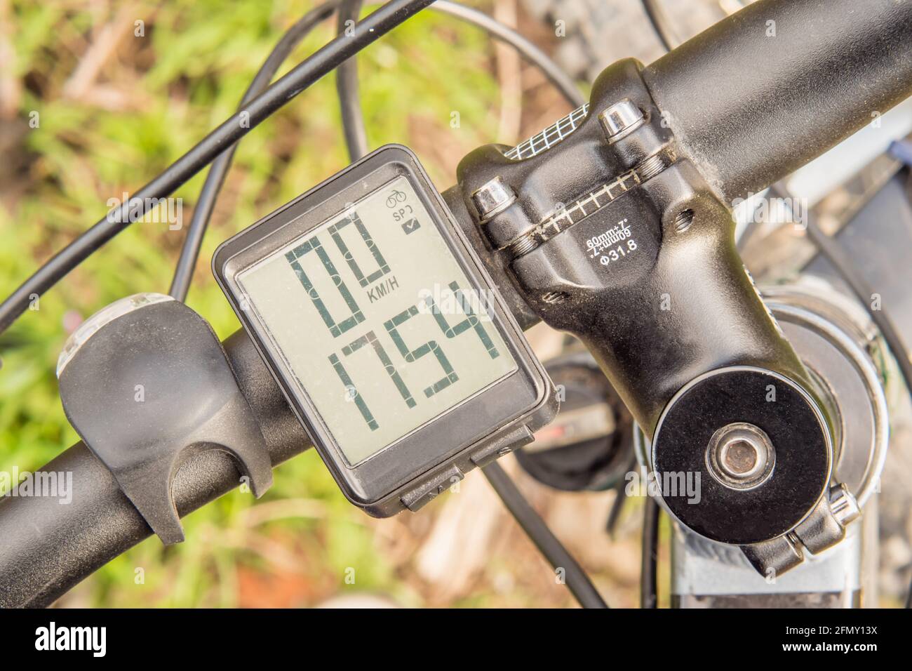 Black mountain bike handlebar with wireless bike computer close-up. Top ...