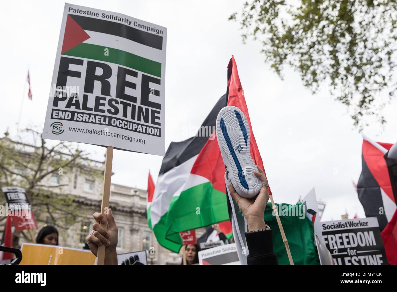 London, UK. 11th May, 2021. A man holds up a Free Palestine placard and ...