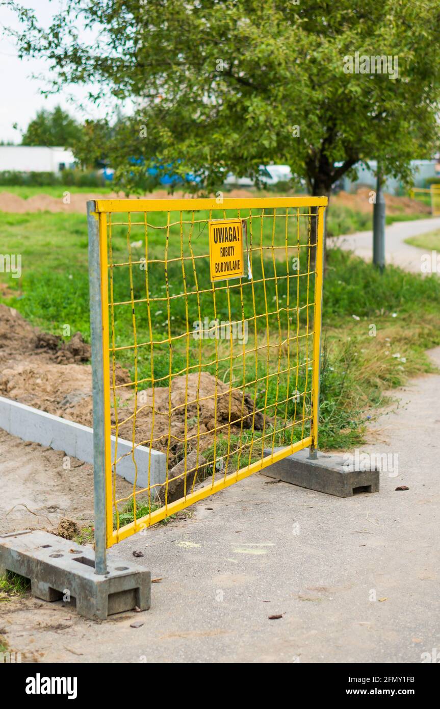 POZNAN, POLAND - Aug 30, 2017: Yellow metal grid barrier with sign ...