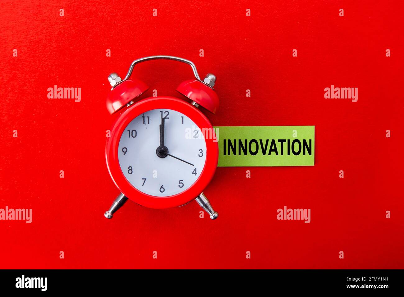 Innovation time has come, Clock on red background Stock Photo - Alamy