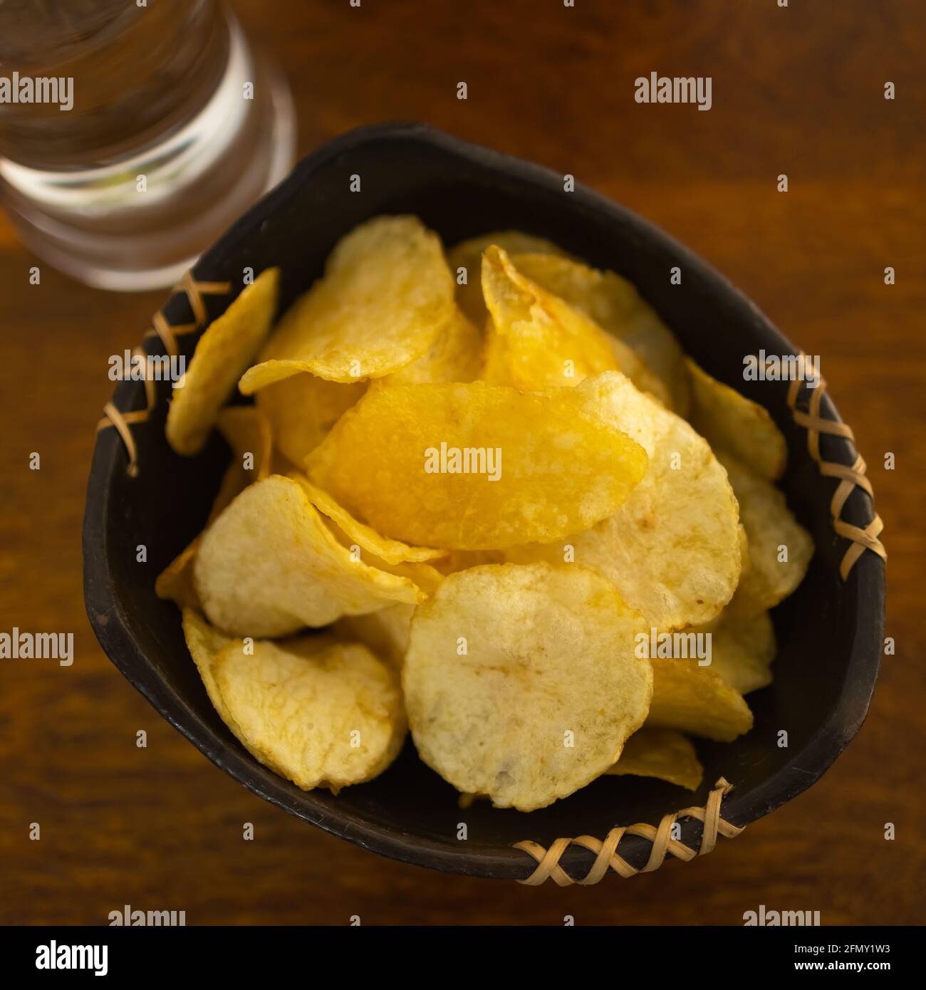 A bowl full of freshly fried golden crispy color potato chips Stock ...