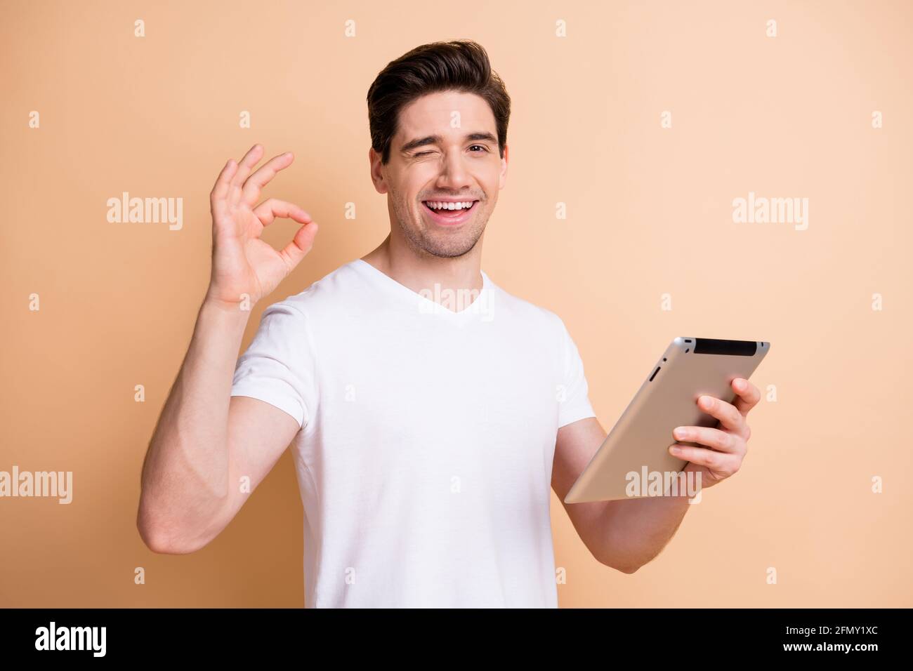 Photo of positive funny person eye wink fingers show okey approve ...