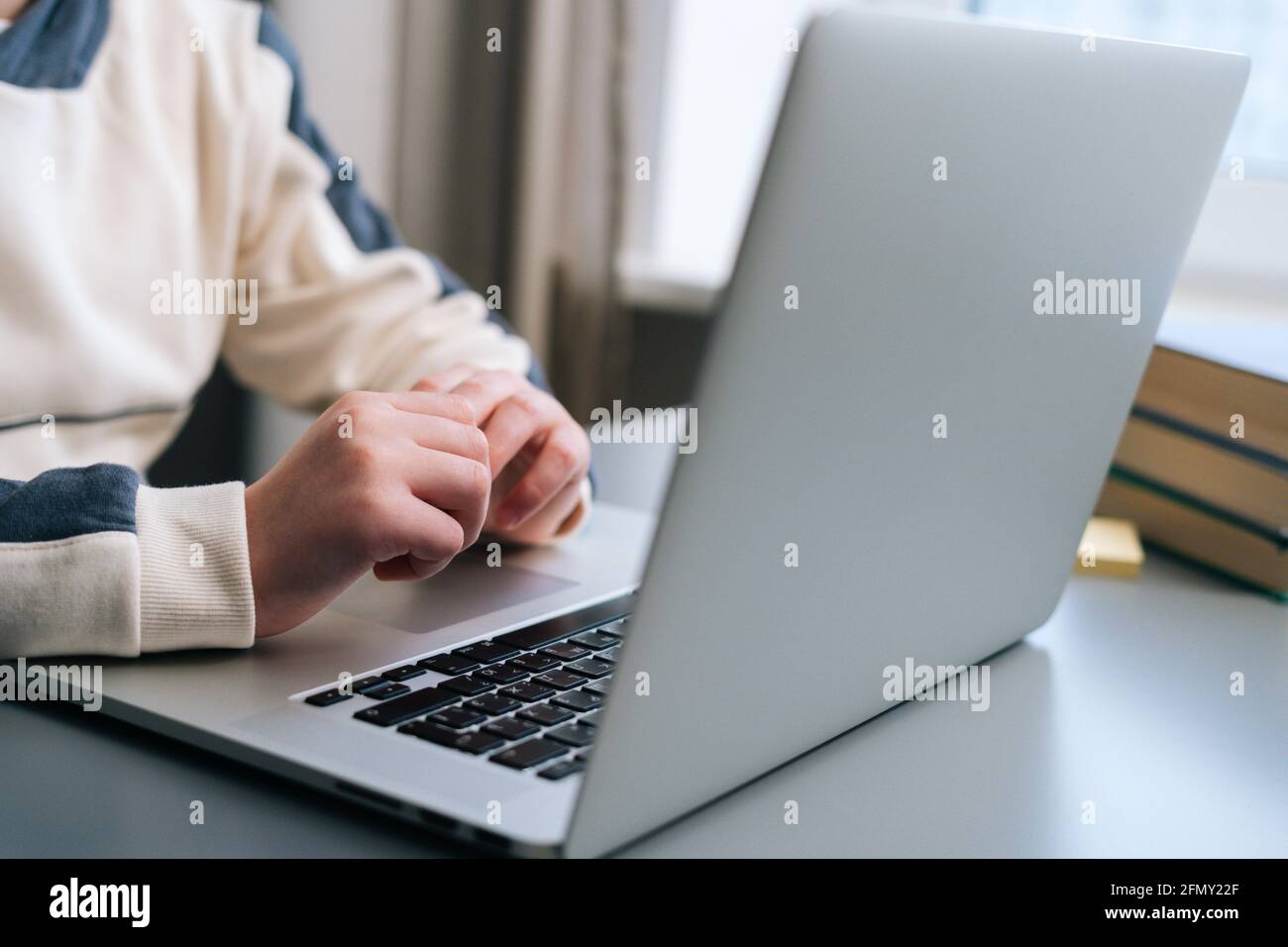 close-up hands unrecognizable child boy typing text using keyboard ...