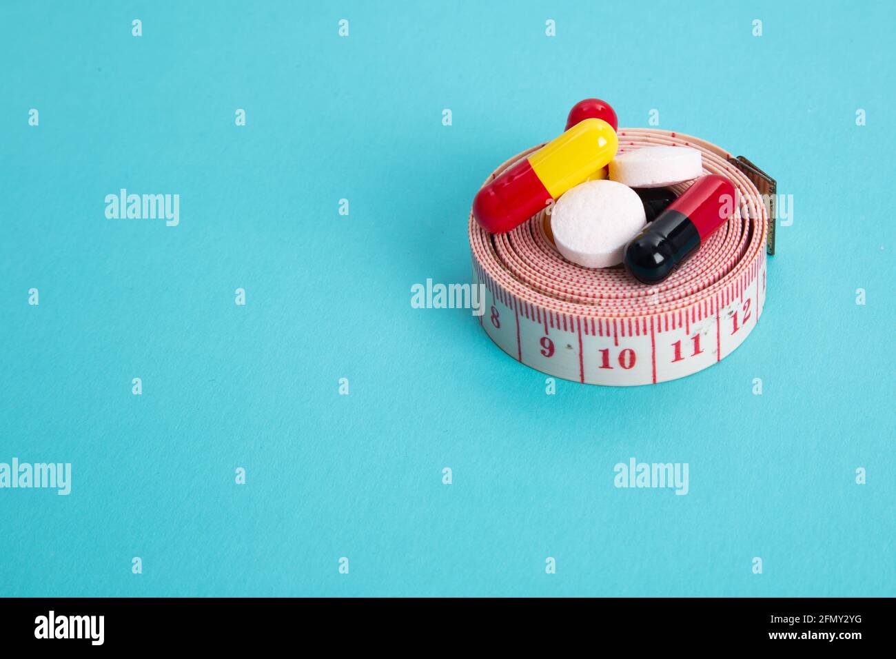 Measuring tape and pills for dieting concept. EKG medical health care ...