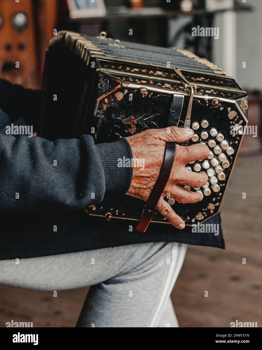Closeup shot of an old man's hand playing Bandoneon musical instrument ...