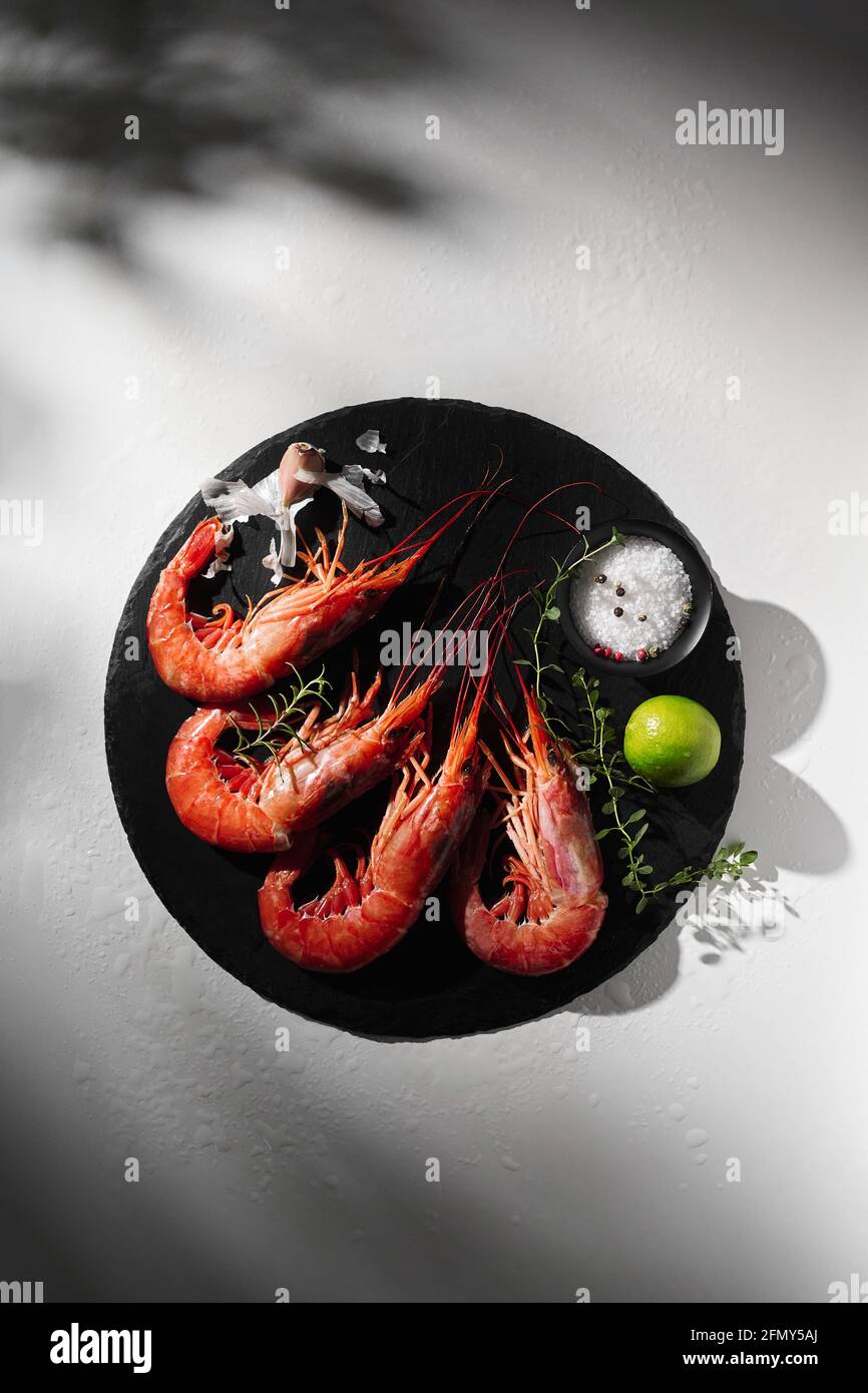 Raw red prawns with condiments on grey background with shadow Stock ...