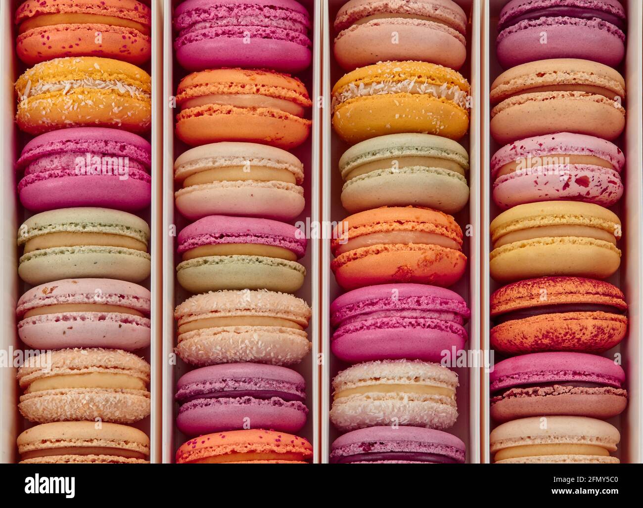Top view of colorful macarons in rows in box Stock Photo - Alamy