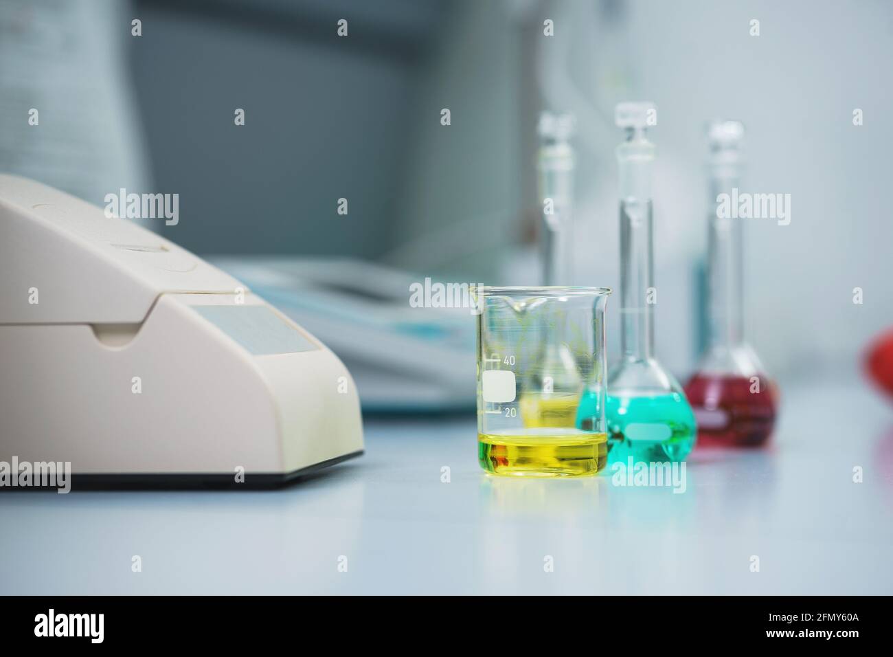 Test tubes and flasks with test liquid on the table in a chemical lab ...