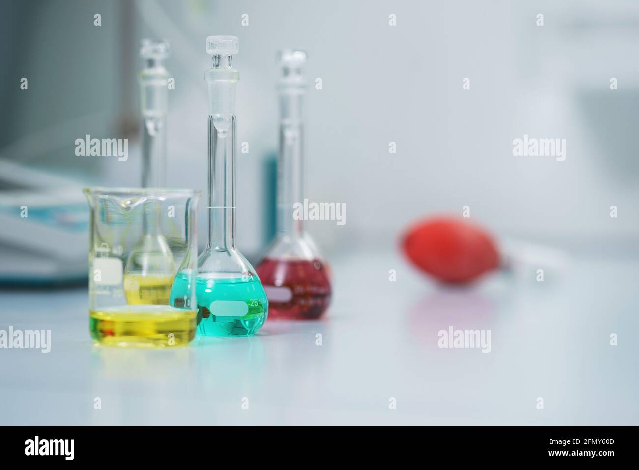 Test tubes and flasks with test liquid on the table in a chemical lab ...