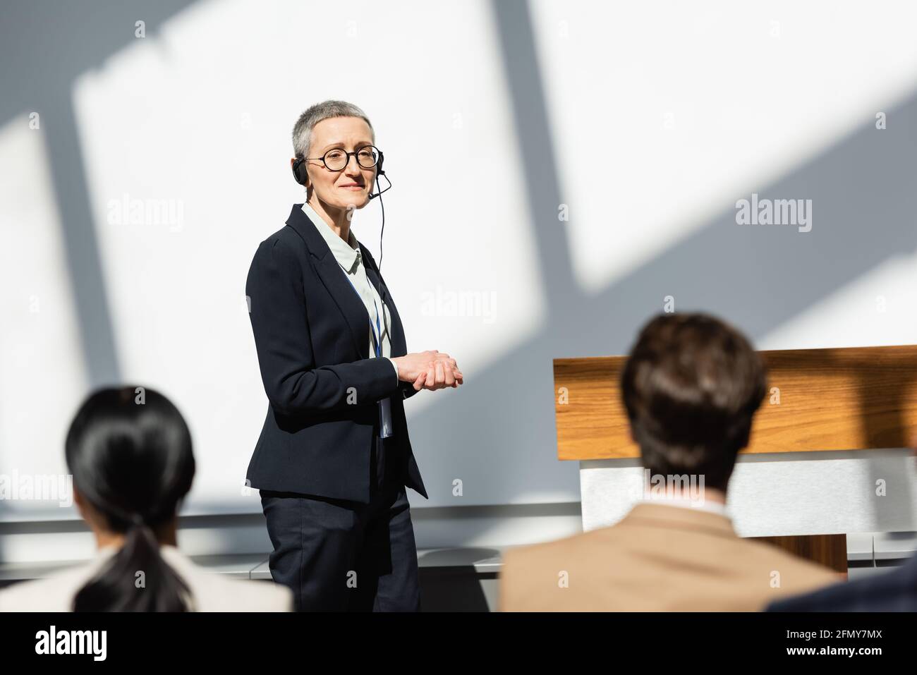 Mature lecturer in headset hi-res stock photography and images - Alamy