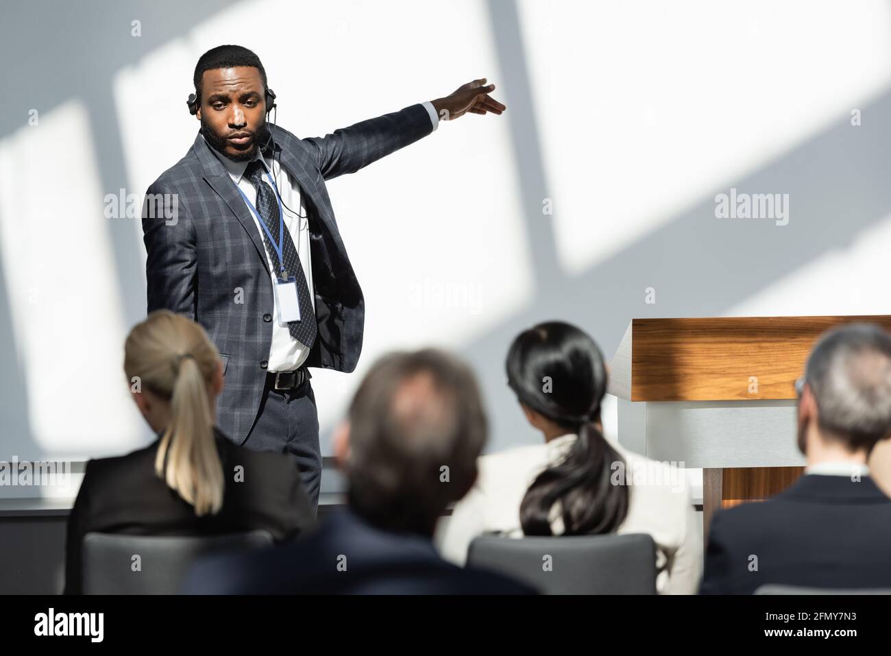 back view of business people near african american lecturer pointing ...