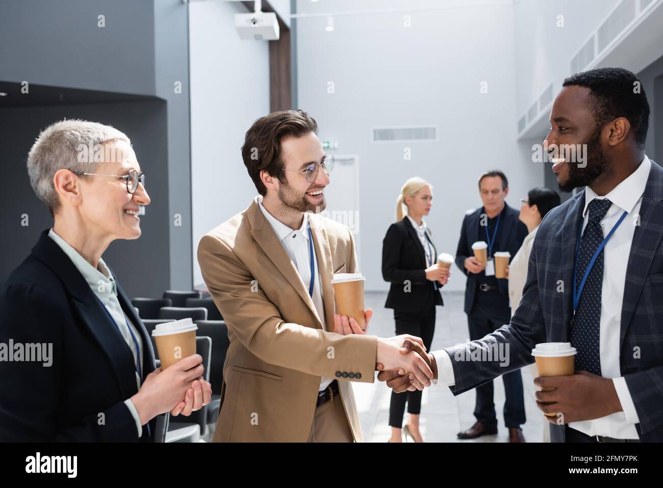 happy multicultural business colleagues shaking hands during coffee ...